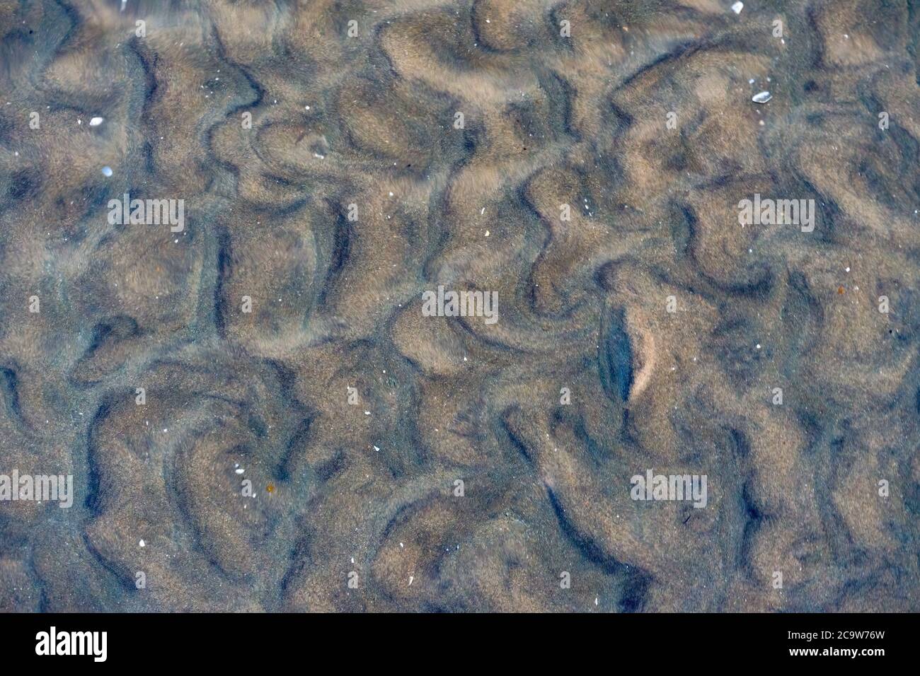 A texture in the sand under flowing water at a beach Stock Photo - Alamy