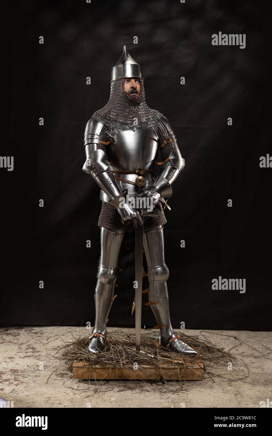 Mannequin man with a beard in a helmet and armor of a knight posing on ...