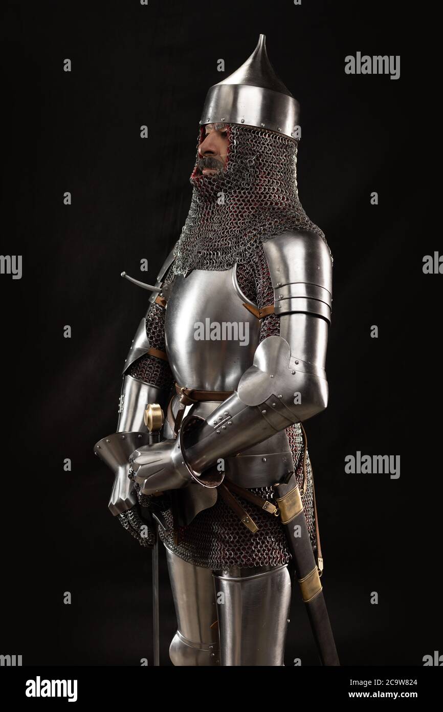 Mannequin man with a beard in a helmet and armor of a knight posing on ...