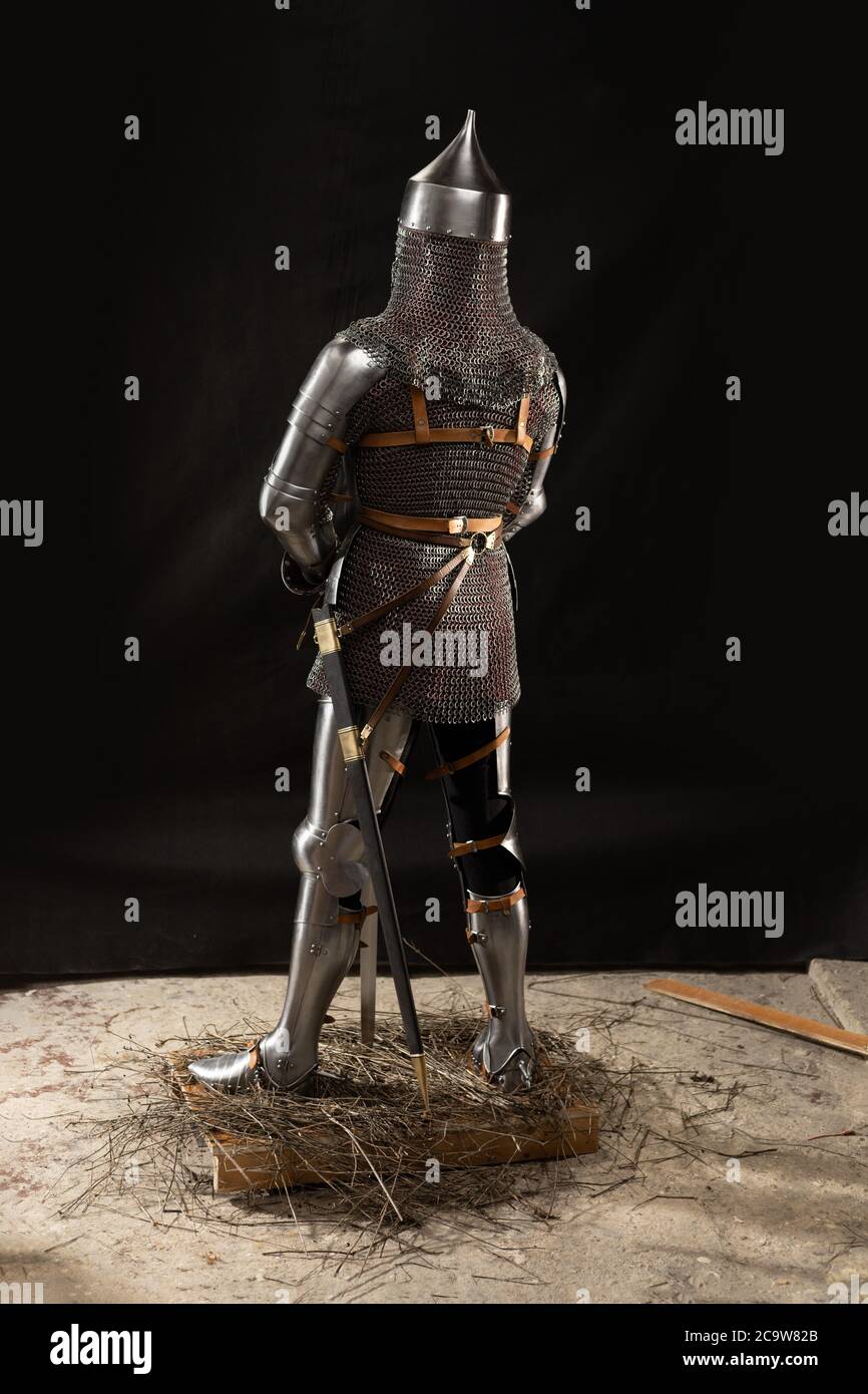 Mannequin man with a beard in a helmet and armor of a knight posing on ...