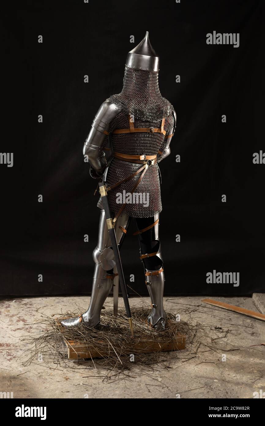Mannequin man with a beard in a helmet and armor of a knight posing on ...