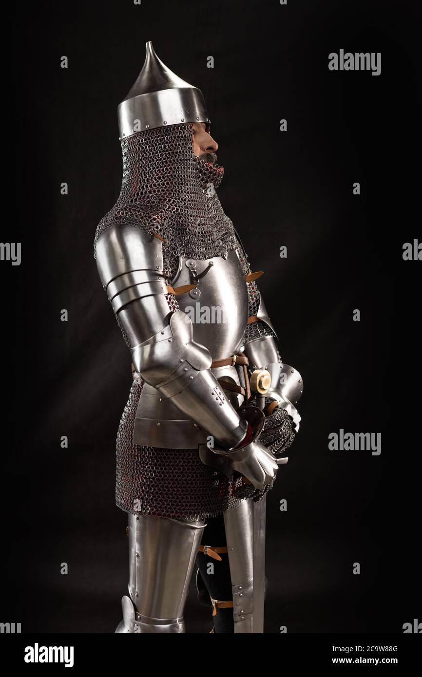 Mannequin man with a beard in a helmet and armor of a knight posing on ...
