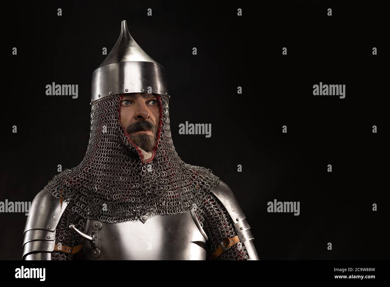 Mannequin man with a beard in a helmet and armor of a knight posing on ...