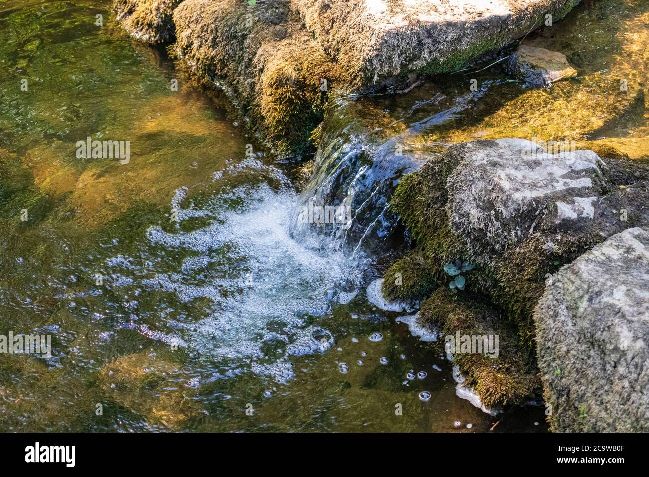Water over stones hi-res stock photography and images - Alamy