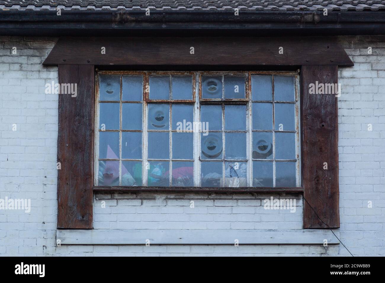 old rusty metal window frames on the front of a derelict house Stock ...