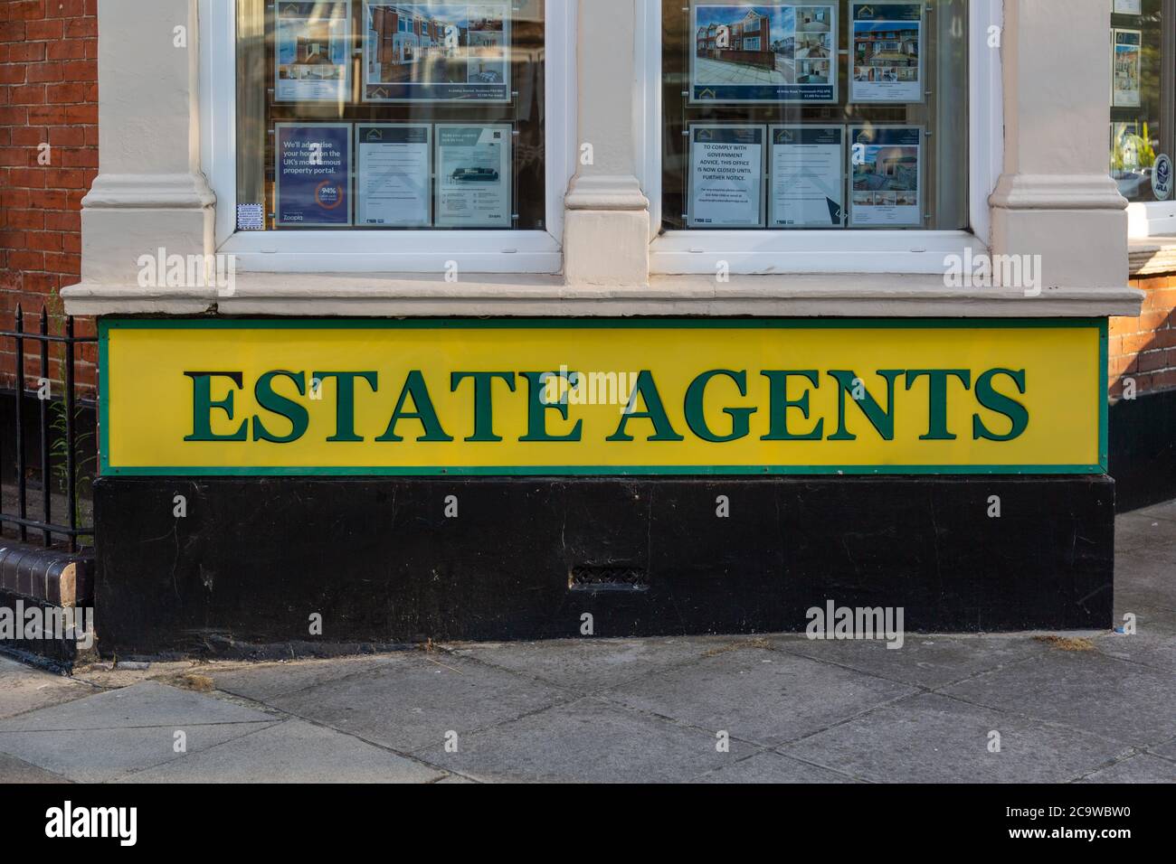 The front or exterior of an English estate agents with an estate agent ...