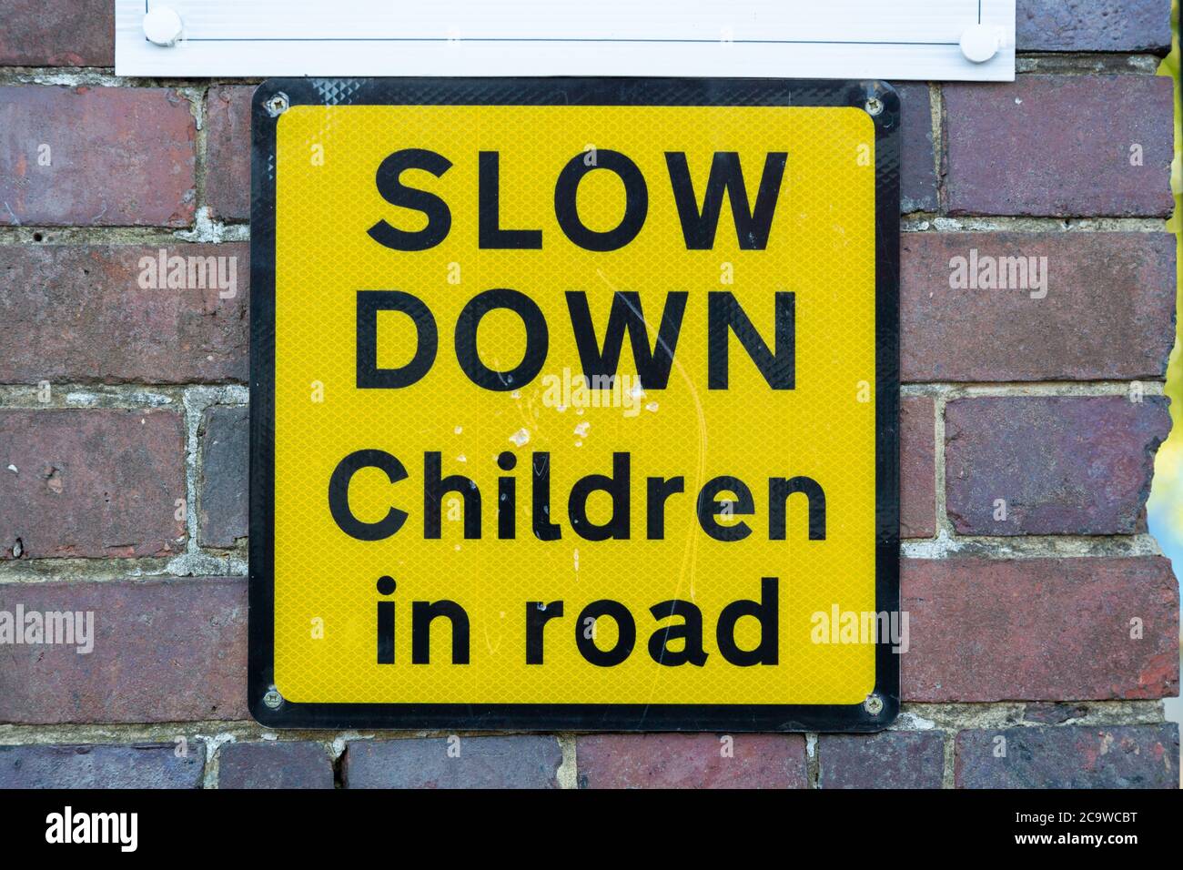 Slow down children in road sign hi-res stock photography and images - Alamy