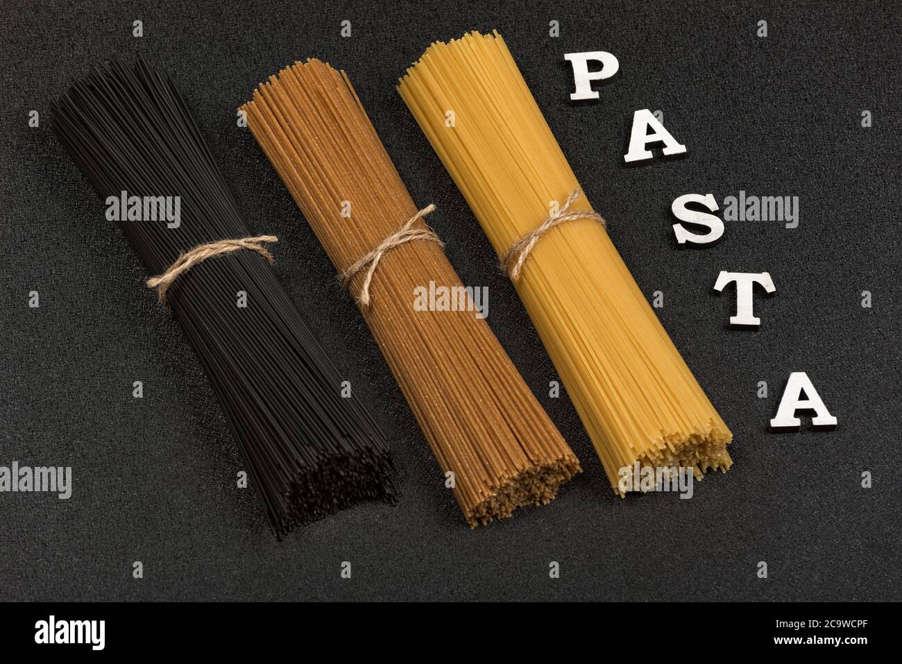 Three types of spaghetti on gray background and word Pasta. Italian ...