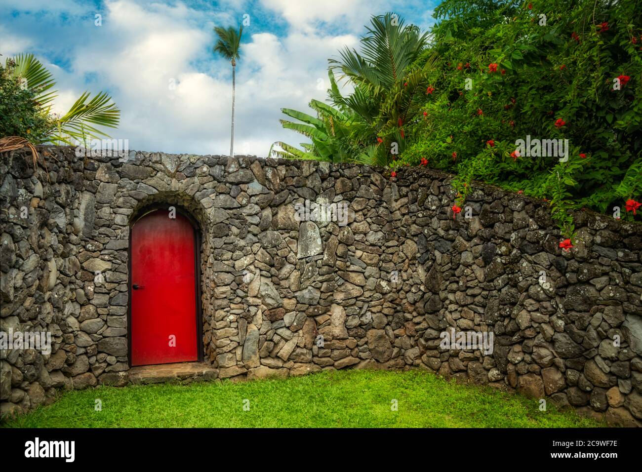 Red door in rock wall. Maui, Hawaii Stock Photo - Alamy