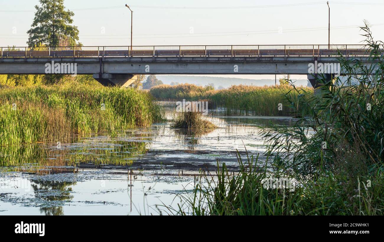 Nature landscape with bridge and small river Stock Photo - Alamy