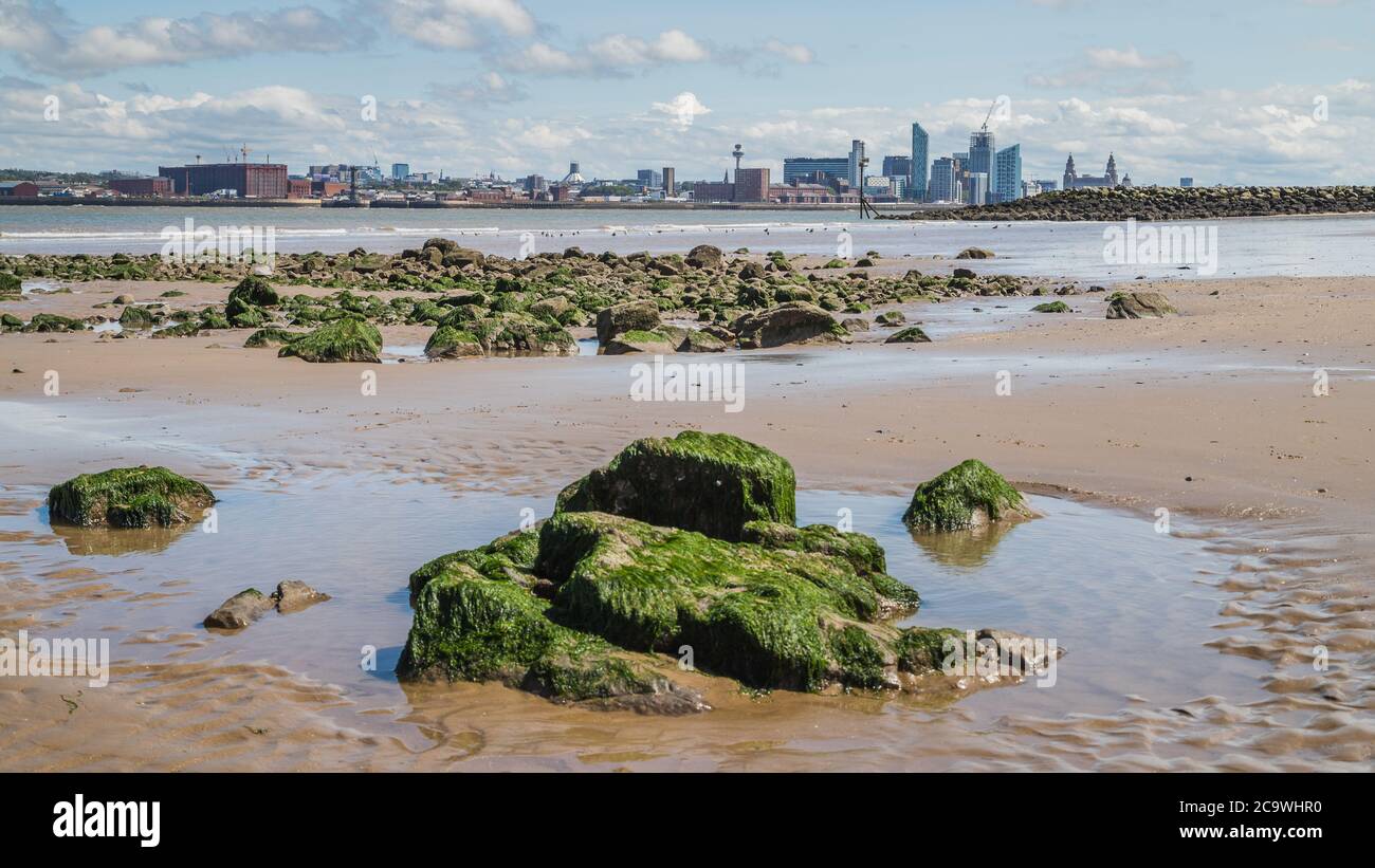 Overlooking rock pools towards trhe Liverpool waterfront seen from the ...