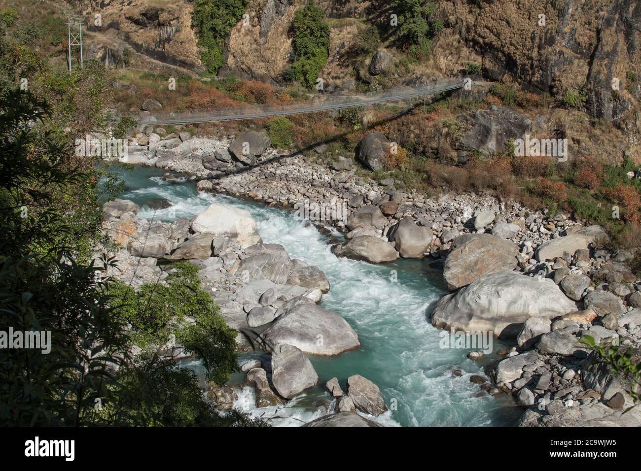 Trekking Nepal, suspention bridge over beautiful Marshyangdi river ...