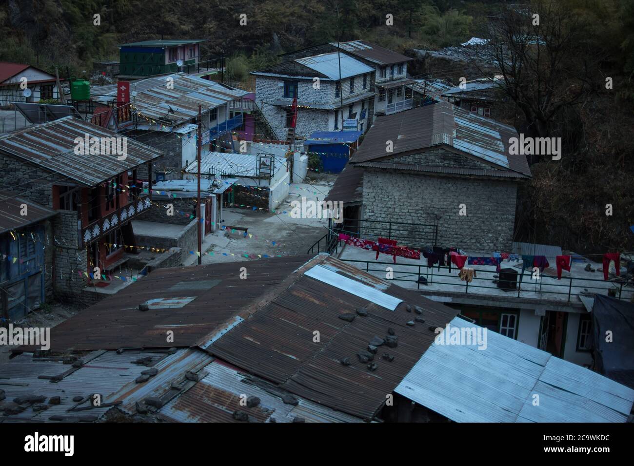 View over the mounatin village Dharapani with prayer flags along ...