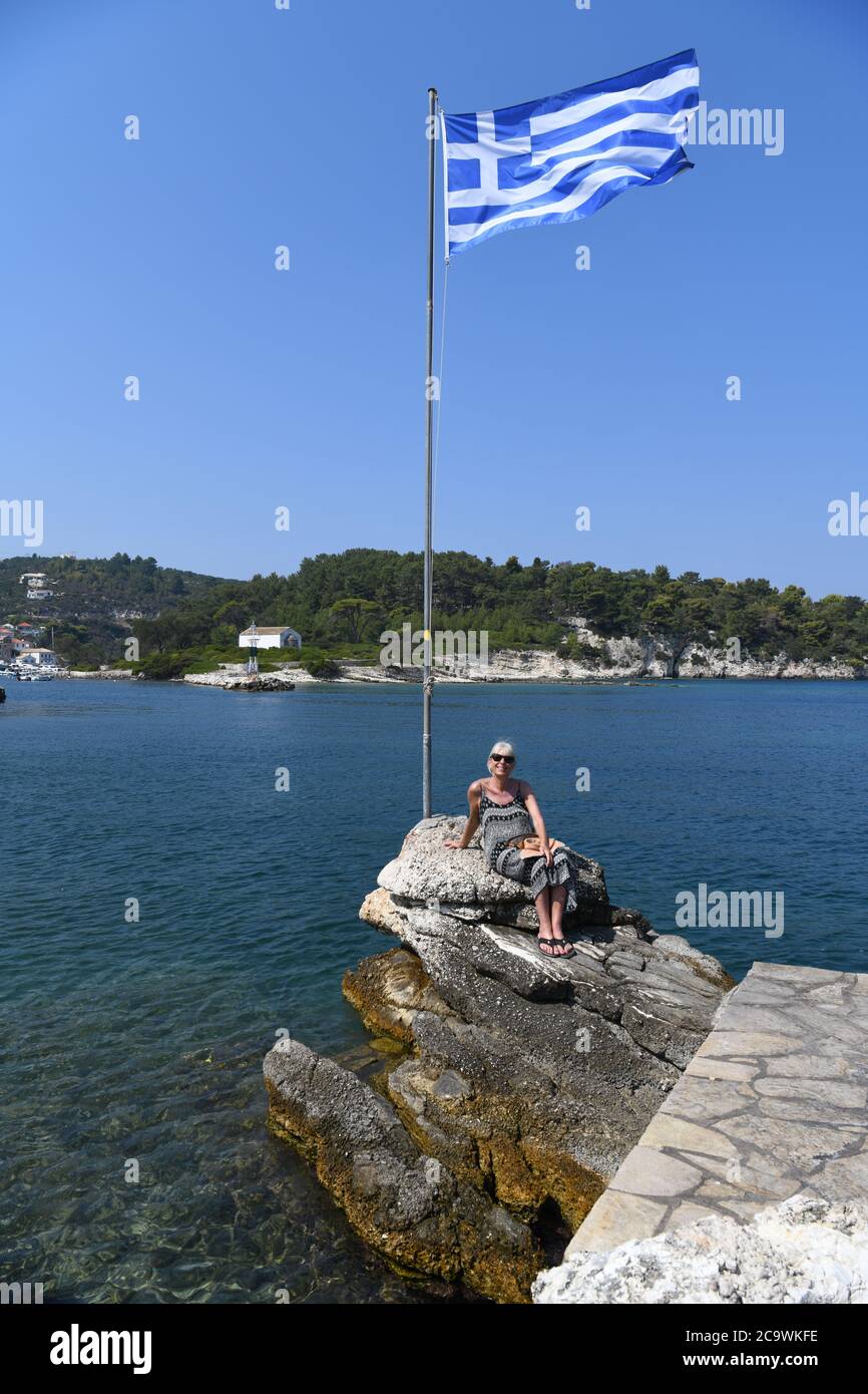 Greek flag flying at the southern entrance to Gaios harbour, Gaios Town ...