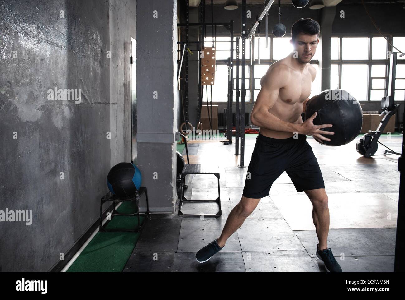 Young strong fit muscular man doing throwing medicine ball up on the ...