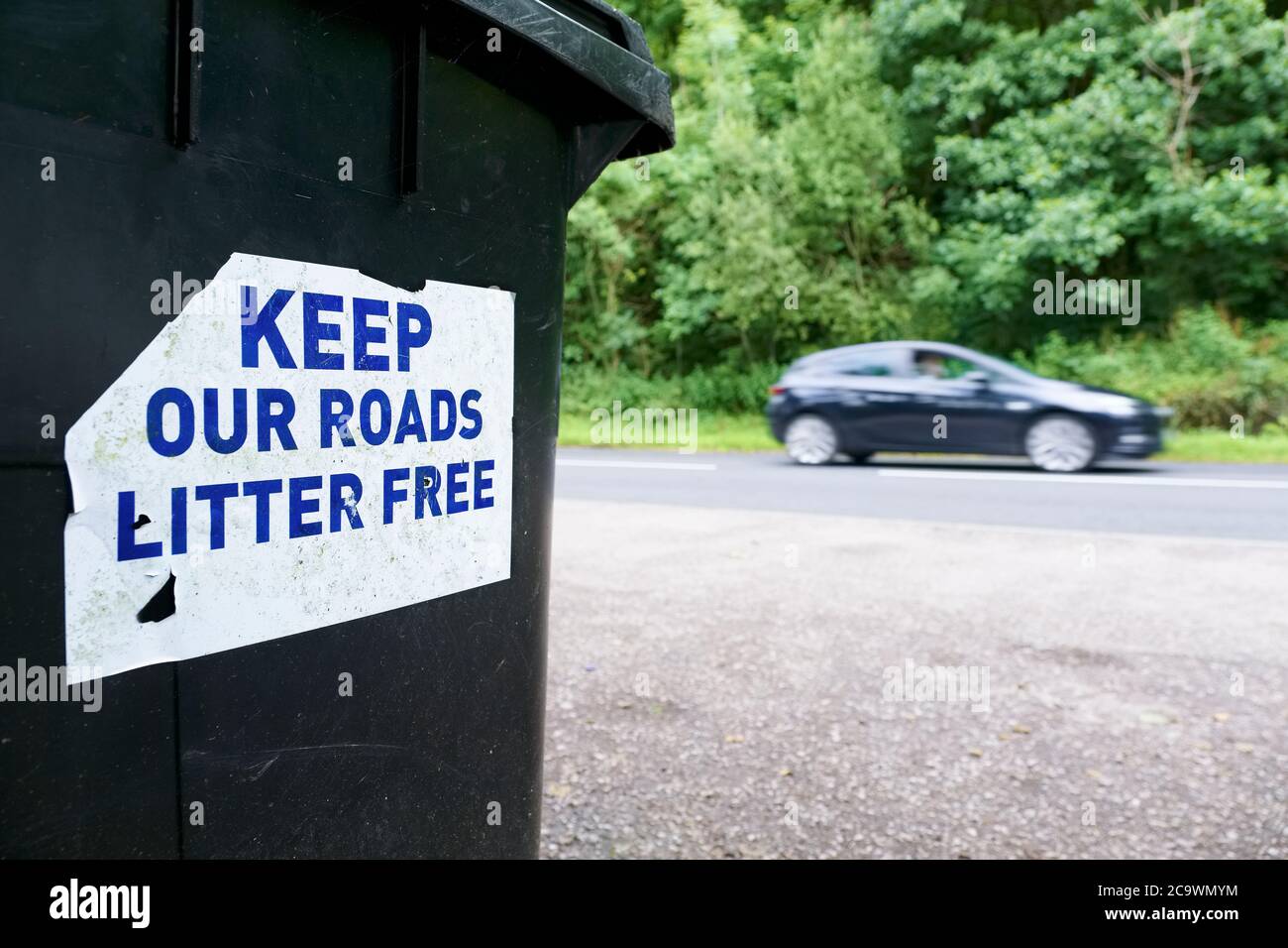 Keep roads litter free sign at roadside on wheelie bin Stock Photo - Alamy