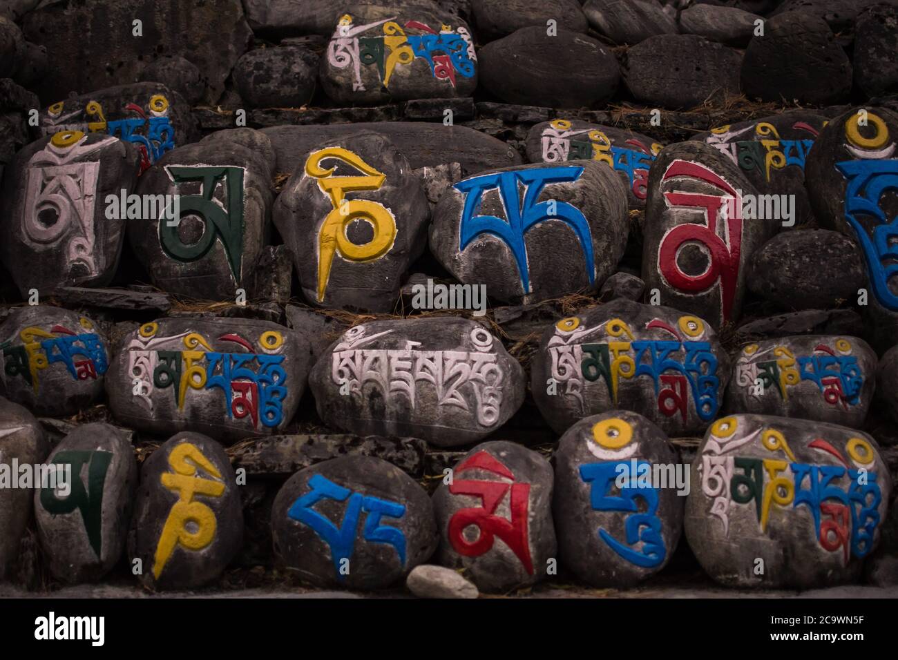 Religious colorful inscriptions in stones, Chame mountain village ...