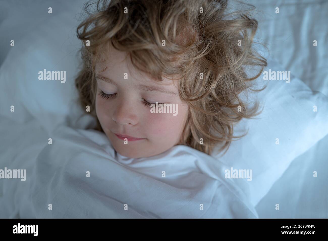 Kids in bedroom sleepin on bed with white sheet and pillow. Eyes closed ...