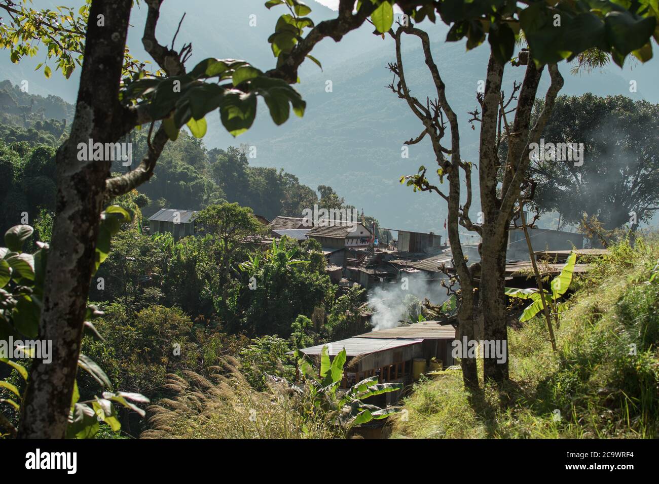 Smoke rising from a beautiful mountain village on the hillside ...