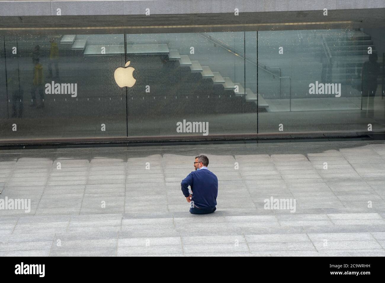 Milan - 6/17/2020 : the glass fountain at Apple store - man taking a ...