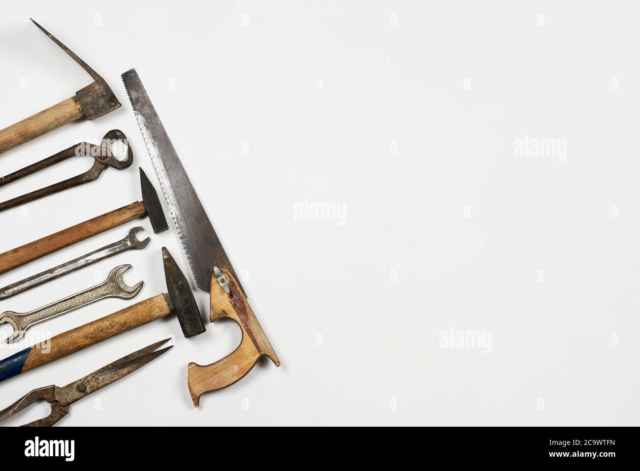 Old and rustic handy working tools on the white background with copy ...