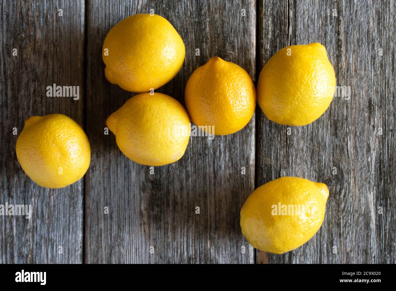 Whole Lemons on Rustic Background Stock Photo - Alamy