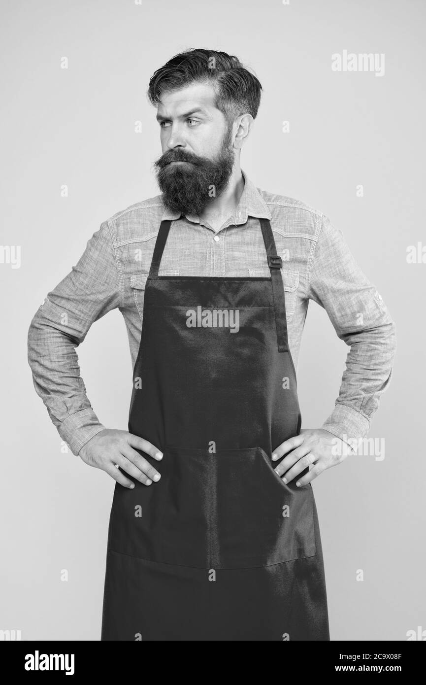 Cooking at home. Helping around house. Bearded man in cook uniform ...