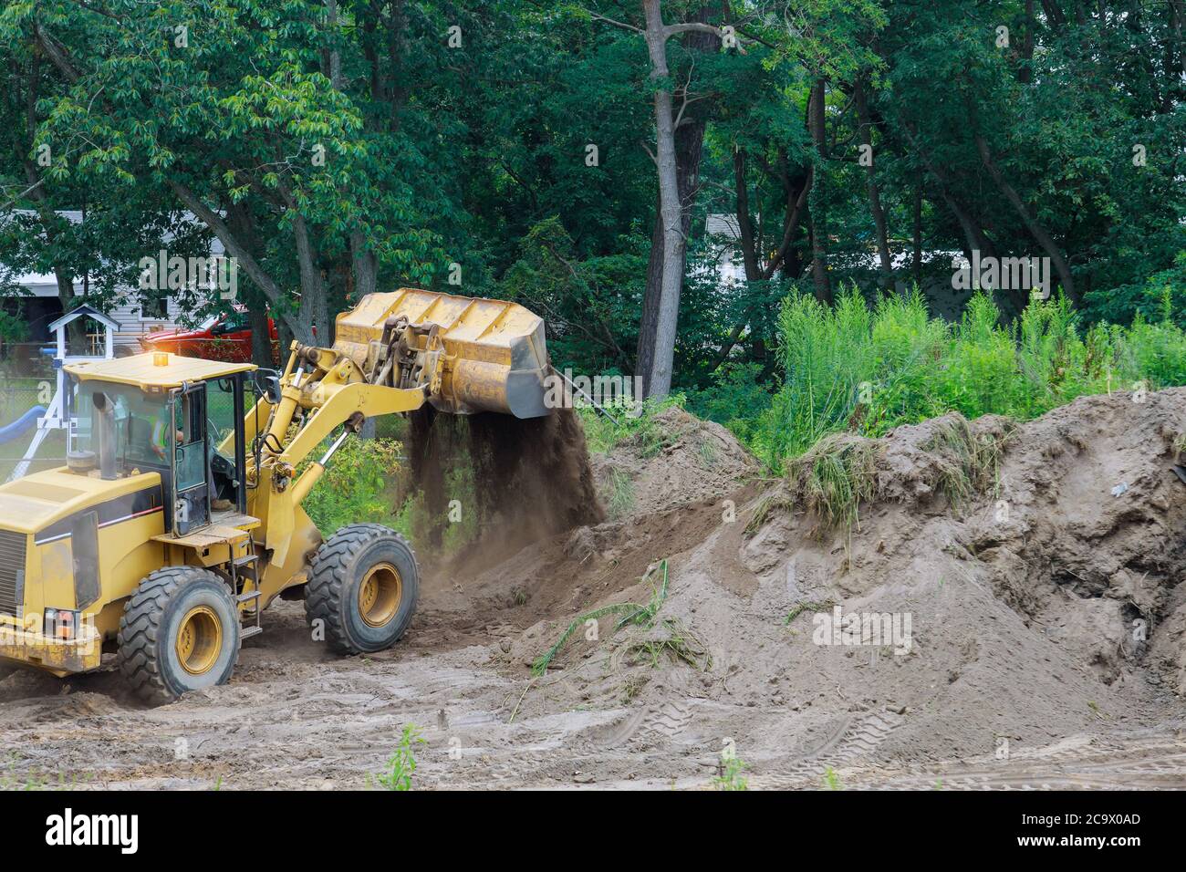 Bulldozer landscaping works on construction working with earth while ...