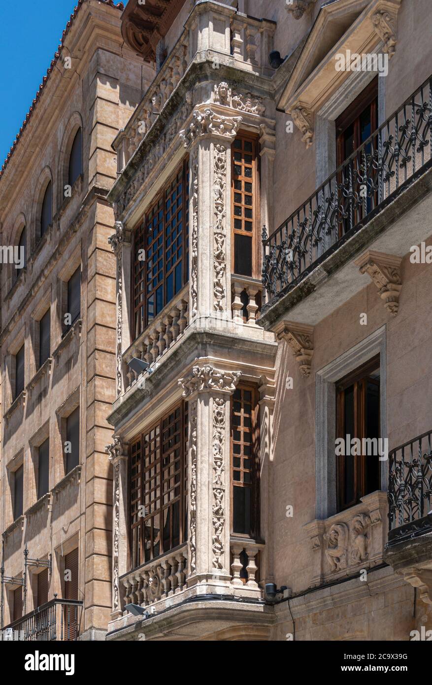 Ornately carved stone window frame of an ancient building in the city ...
