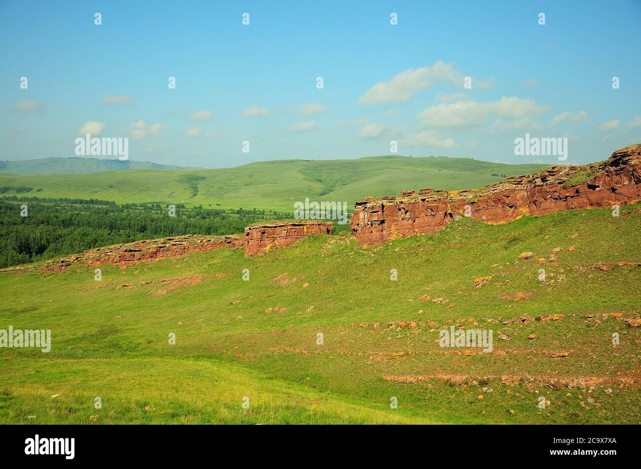 The ridge of a high hill overgrown with grass and stone walls ...