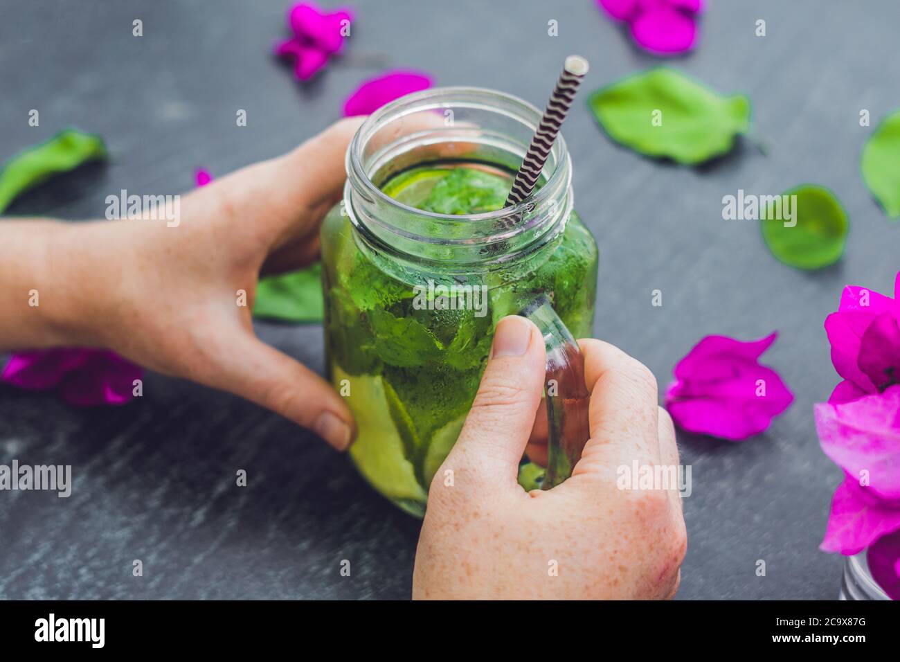 Spring purple flowers and spring mojito drink on an old wooden ...
