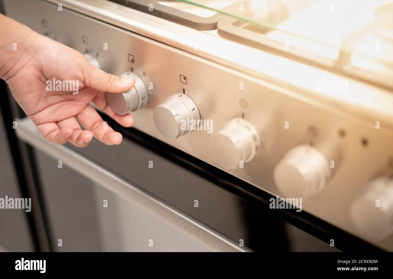 Close up female hand Opening Or Closing modern electric oven prepare to ...