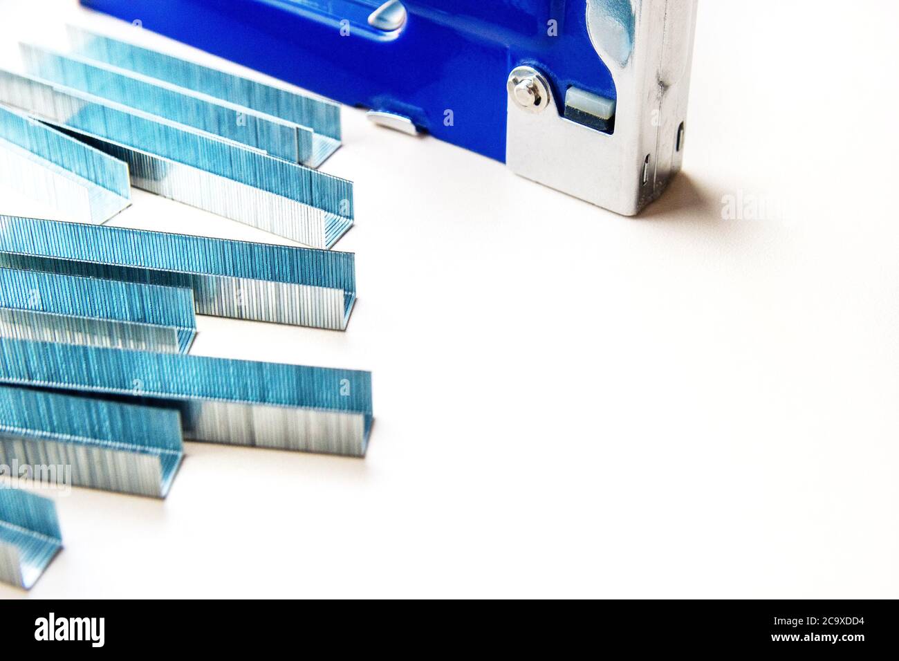 Blue industrial stapler gun with staples, furniture industry hardware ...