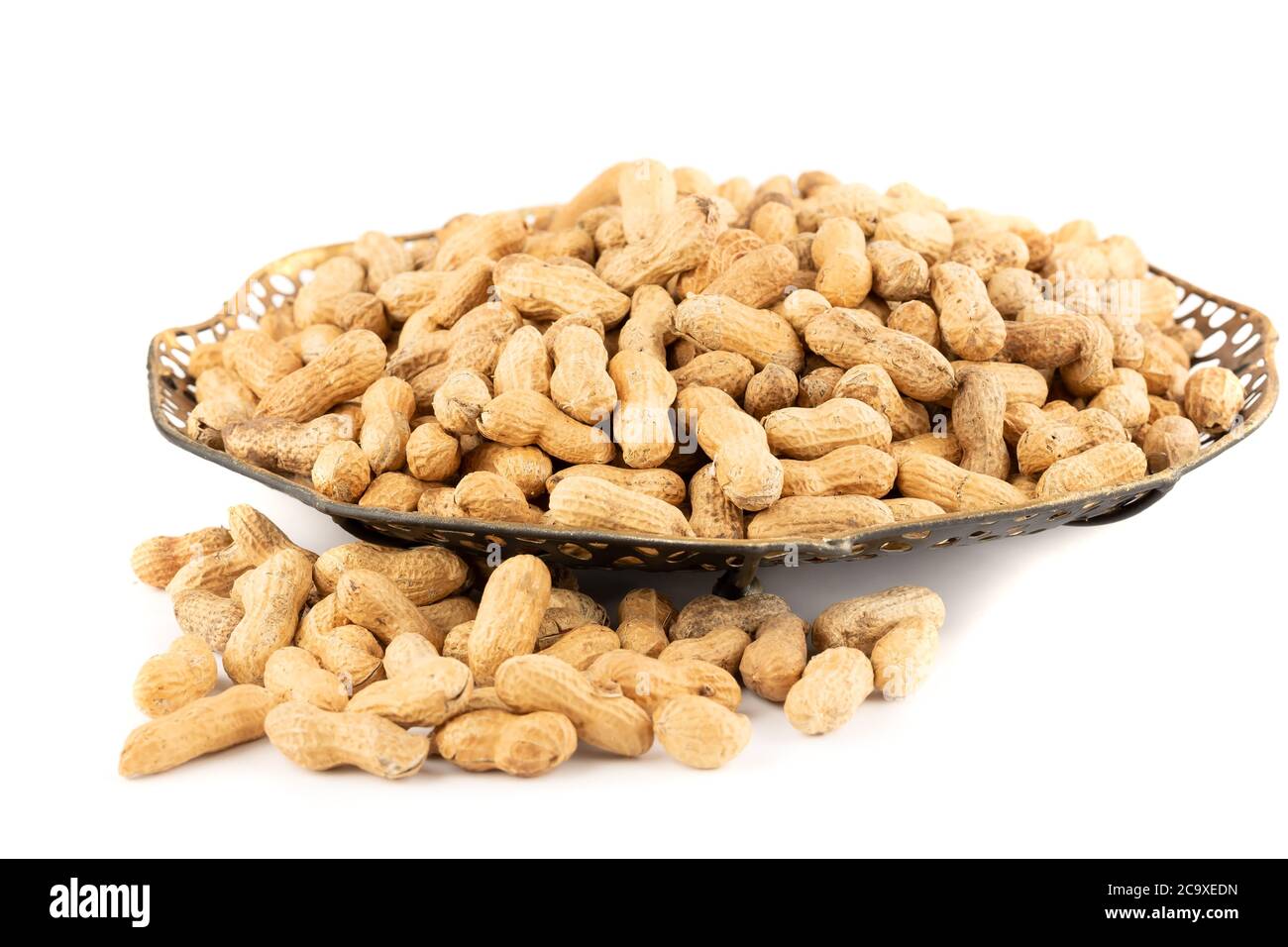 Peanuts in shell in the metallic vintage vase isolated on white ...