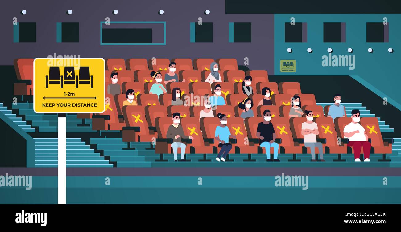people in protective masks watching movie keeping distance to prevent ...