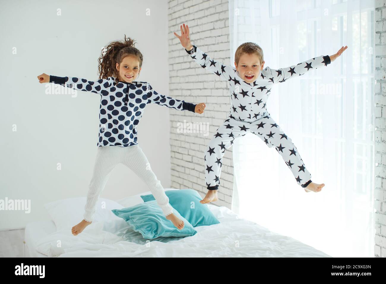 Children jump on the bed Stock Photo - Alamy