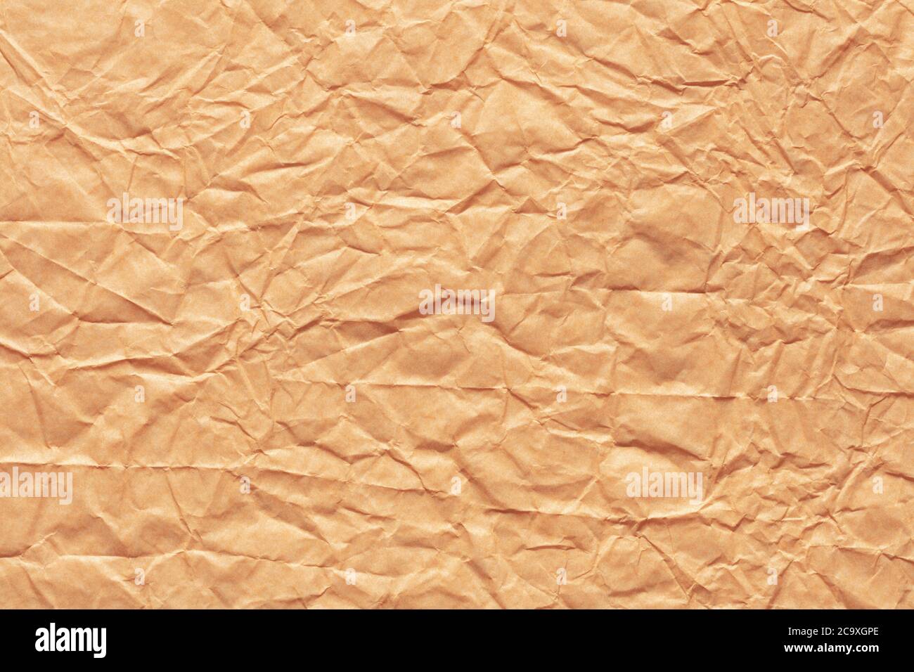 Crumpled paper background in peach color for your new stylish greeting ...