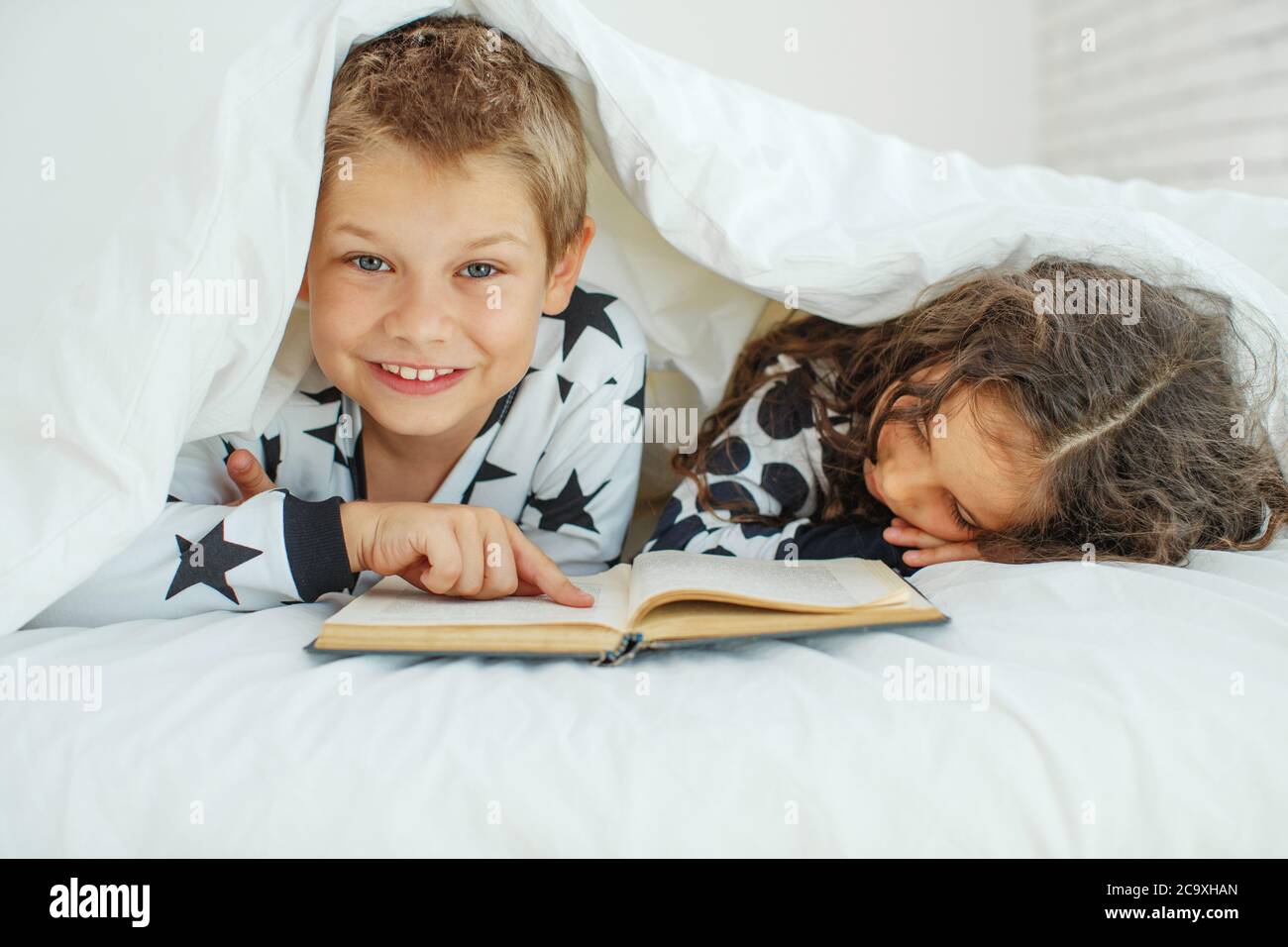 Children are reading a book Stock Photo - Alamy
