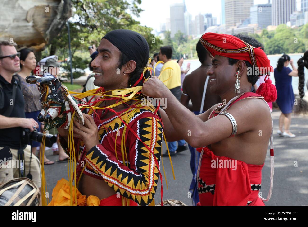 A Chitrasena Dance Company dancer helps another dancer take off his ...