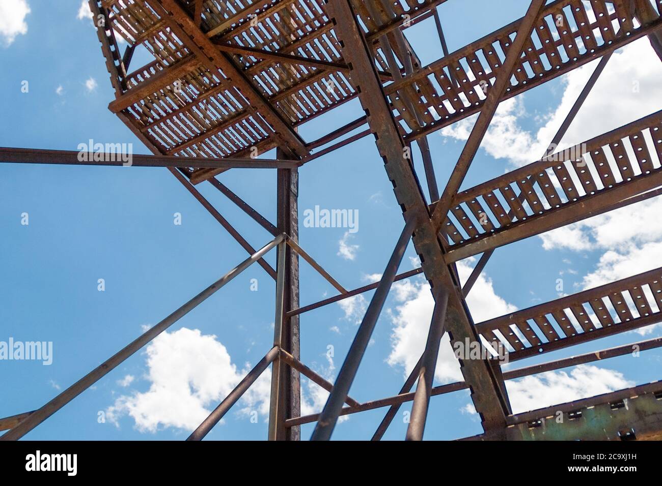 old rusty metal ladder in a blue sky with clouds Stock Photo - Alamy