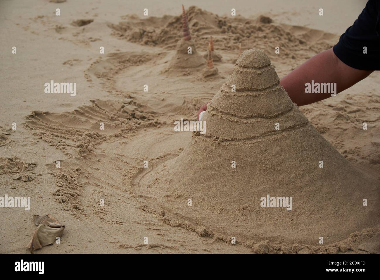 Making Buddhist temples form sand on the beach. Using seashells to be ...