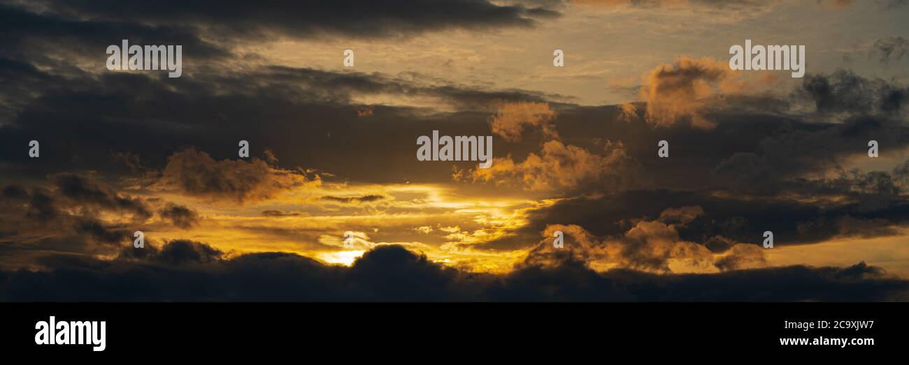 Panoramic view of dramatic clouds rising of sun floating in sky to ...