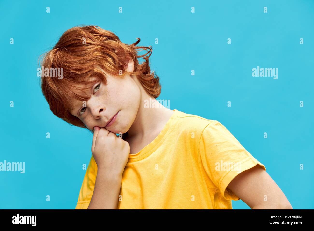red-haired boy with a boring expression leaned to the side Stock Photo ...