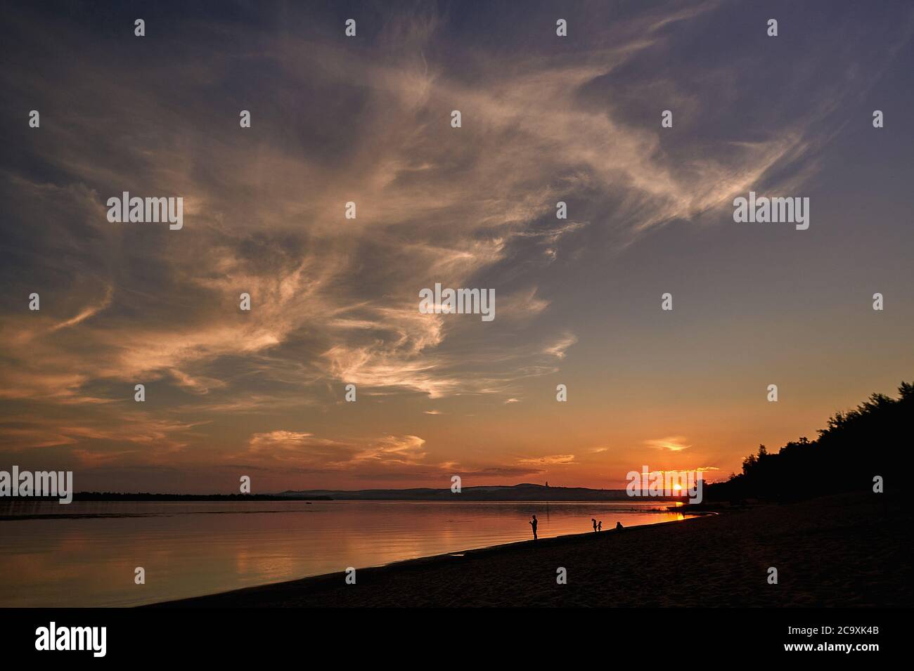 A sunset over a body of water Stock Photo - Alamy