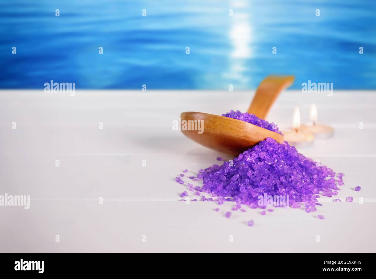 Salt violet bath in wooden spoon on table white Stock Photo - Alamy
