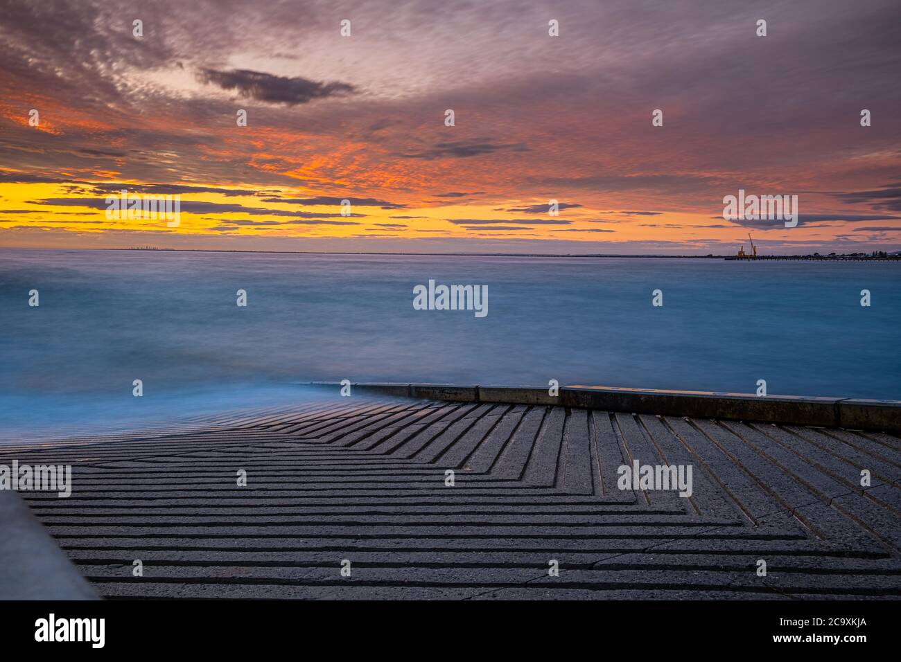 Boat ramp on ocean shore at sunset - long exposure seascape Stock Photo ...