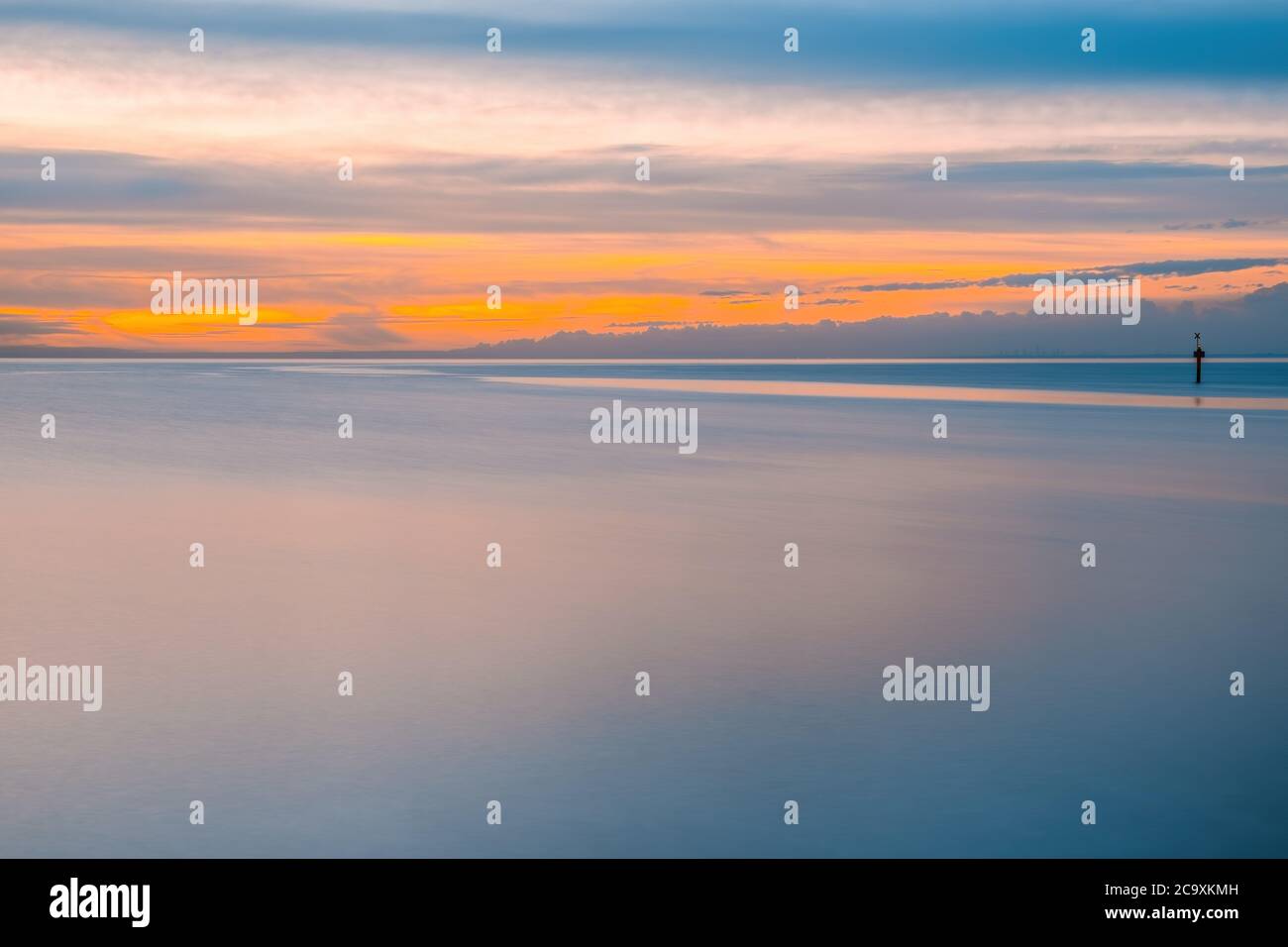 Silky smooth water at sunset over ocean with copy space Stock Photo - Alamy