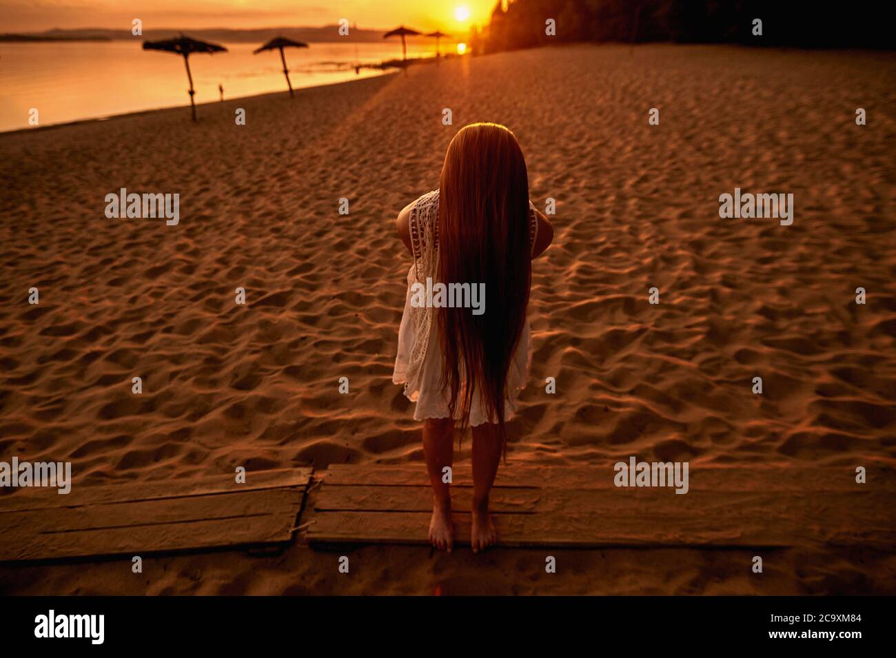 A person standing in front of a sunset Stock Photo - Alamy