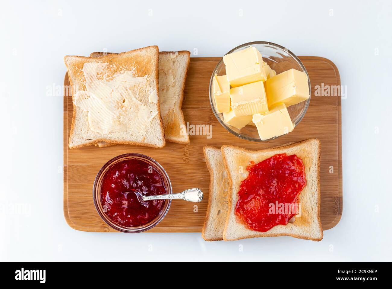 White bread toast with butter and strawberry jam hi-res stock ...