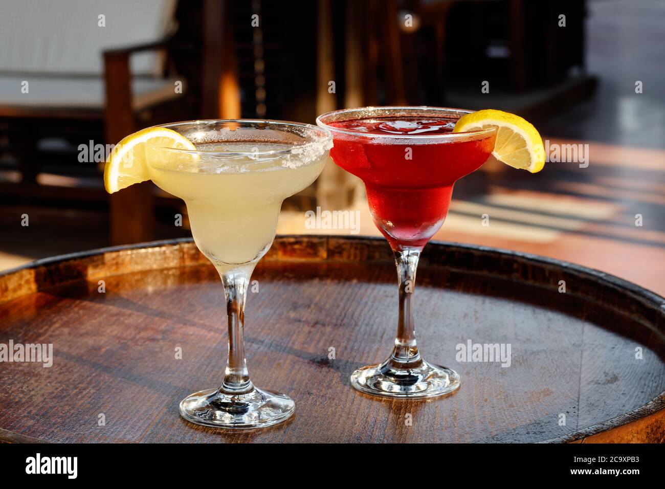 A glass of cocktail at the bar. Two sweet cocktails Cosmopolitan and ...